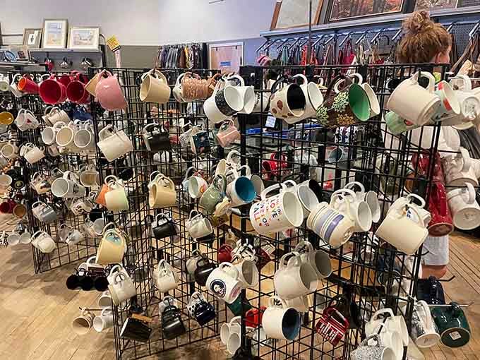 Coffee mugs hanging like a ceramic art installation, because apparently everyone needs thirty-seven ways to drink their morning joe.