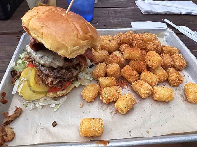Look at that towering burger with its golden tots army standing guard, ready for battle in your belly.