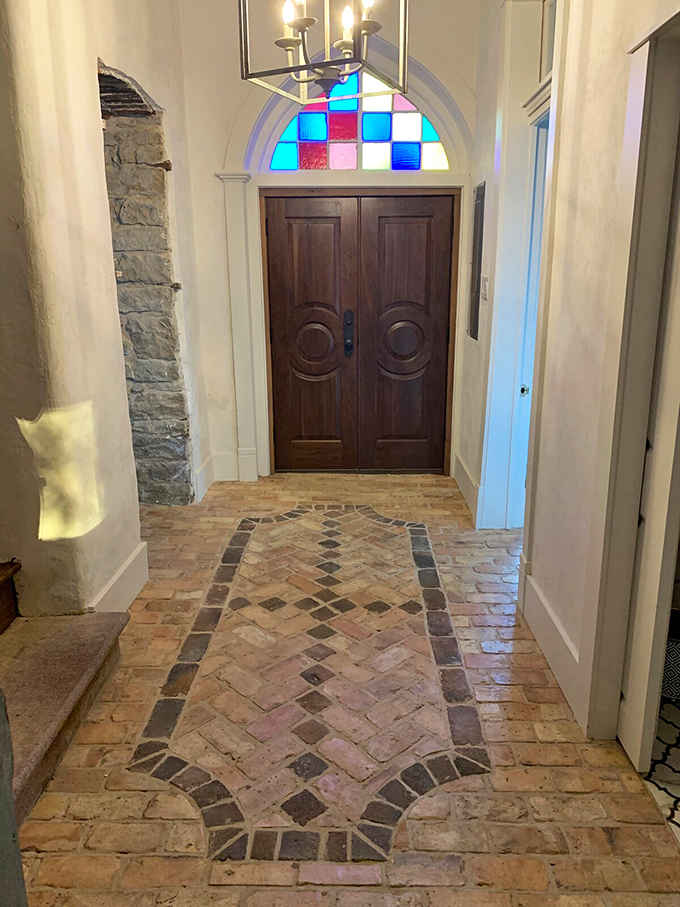 Those colorful stained glass panes above the entrance add a touch of whimsy to serious stonework below.