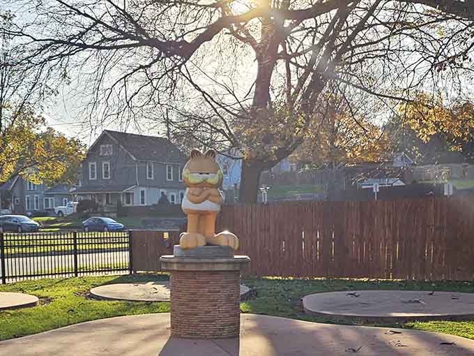 Perched atop his pedestal like a furry orange Buddha, dispensing wisdom about naps and Monday hatred.