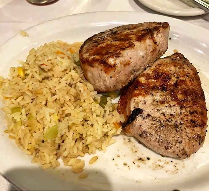 Perfectly grilled pork chops with rice pilaf prove that sometimes the classics need no ghostly embellishments to shine.