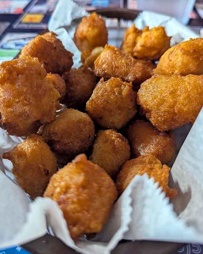 Golden, crispy, and bottomless, these hushpuppies are the opening act that steals the entire show every single time.