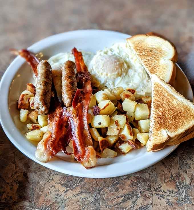 Sausage, bacon, eggs, home fries, and toast prove breakfast doesn't need to be complicated to be perfect.