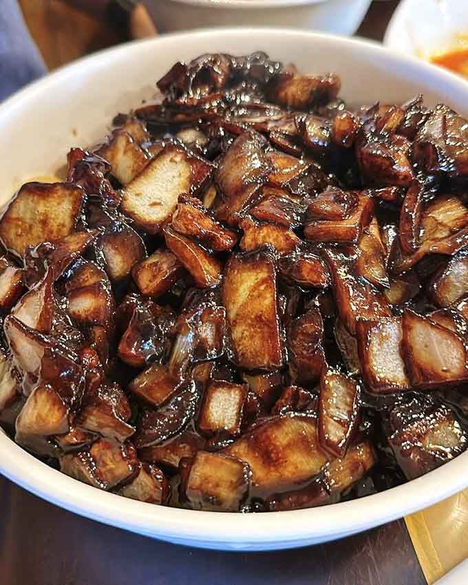 Jajangmyeon's glossy black bean sauce coating those noodles like edible silk. Don't fear the dark side here.