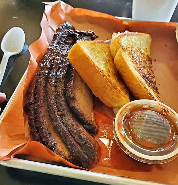 That smoke ring and bark tell you everything: this brisket has been loved low and slow to perfection.