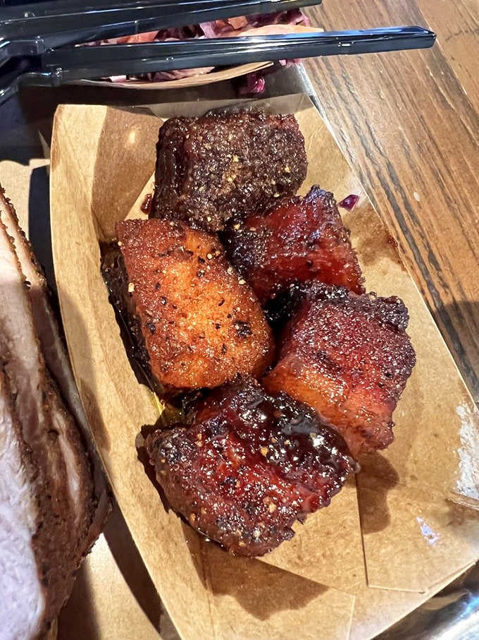 Behold the bacon burnt ends: crispy-edged cubes of pork belly perfection that redefine indulgence completely.