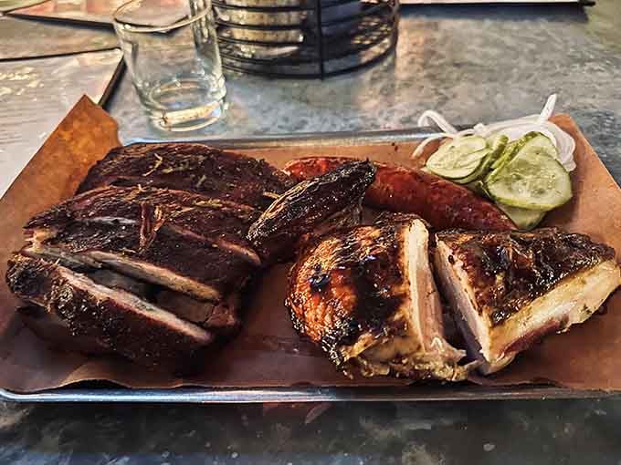 Behold the holy trinity: brisket, ribs, and sausage on butcher paper, just like the barbecue gods intended it.