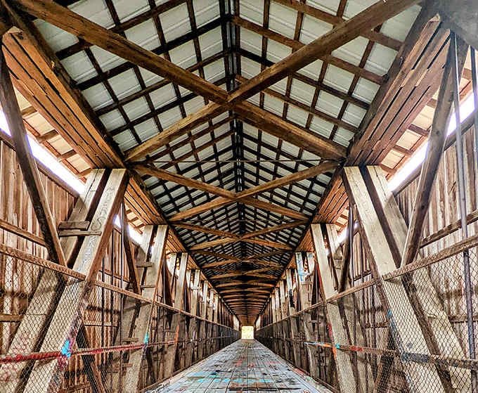Inside, the Howe truss system creates geometric patterns that would make any engineer weep with joy.
