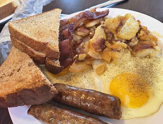 This is what breakfast should look like: eggs, bacon, sausage, toast, and hash browns in perfect harmony.