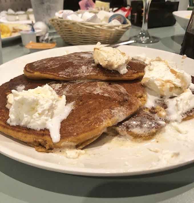 Pumpkin pancakes topped with whipped cream, because sometimes adulting means ordering dessert disguised as breakfast and feeling zero guilt.