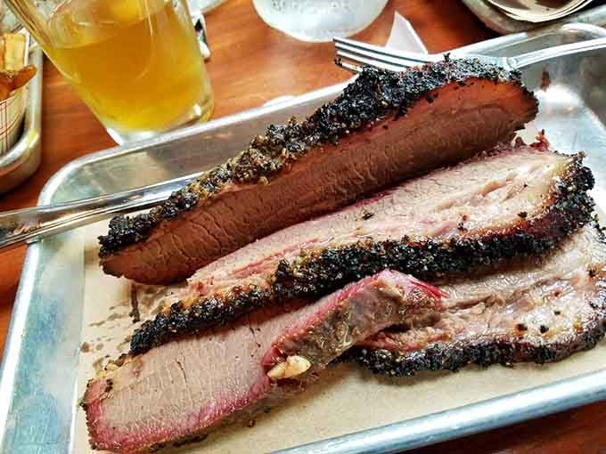 Behold the brisket: dark bark, pink smoke ring, and enough flavor to make grown adults weep with joy.