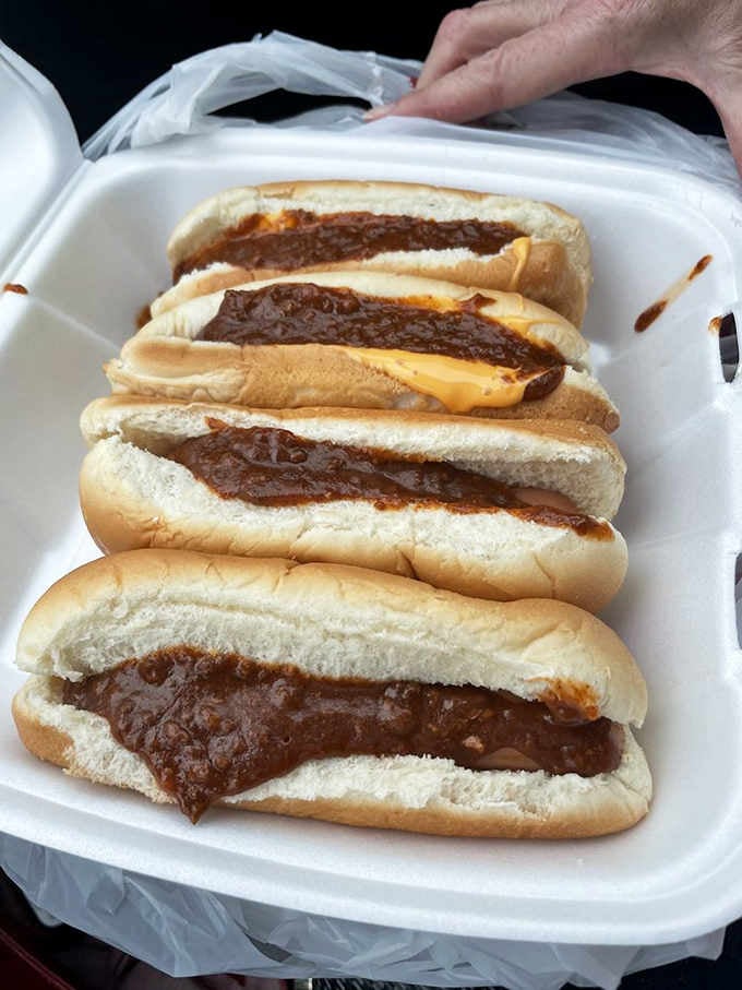 Four chili cheese dogs lined up like edible soldiers, ready to wage delicious war on your hunger.