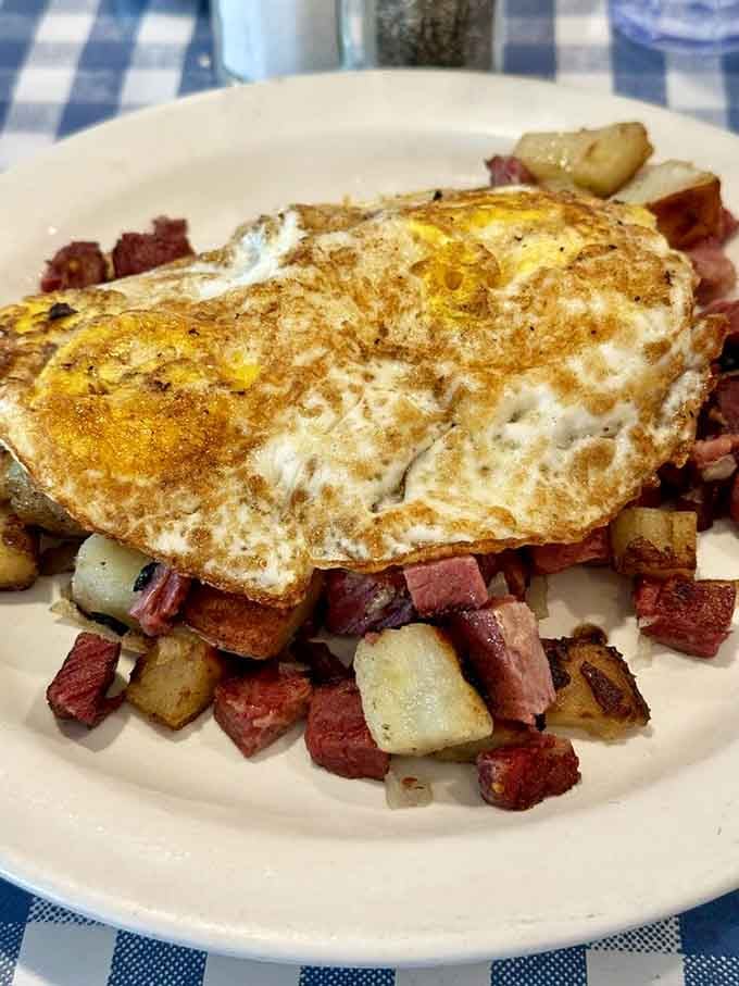 Corned beef hash topped with perfectly fried eggs—this is what breakfast dreams are made of, folks.