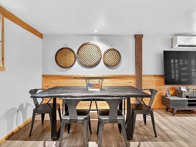 Industrial-chic dining beneath woven basket art offers a surprisingly elegant contrast to the dinosaur theme throughout the property.