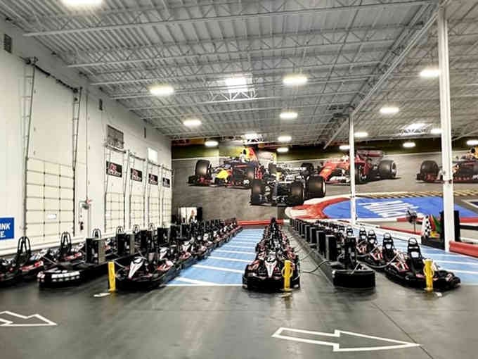 Rows of electric karts waiting like eager racehorses, ready to pin you back in your seat with instant torque.