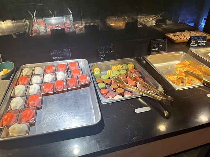 Macarons and gelatin cups lined up like edible soldiers ready to wage sweet warfare on your willpower and waistline.