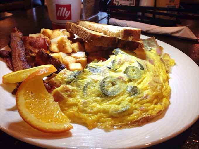 This breakfast plate means business: fluffy omelet, crispy bacon, golden toast, and enough fuel to conquer your day.