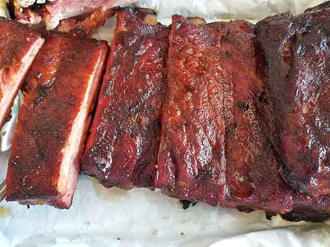 These ribs have that perfect mahogany bark that barbecue dreams are made of, glistening like edible treasure.
