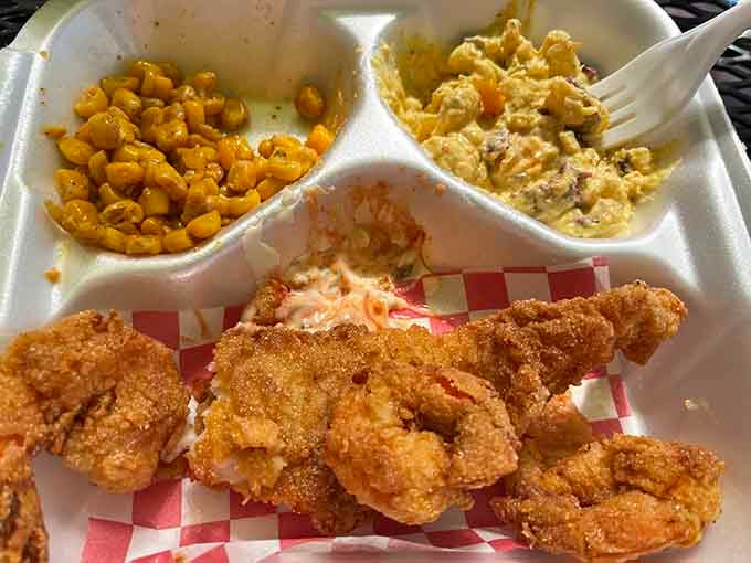 Golden fried shrimp with sides that could make a Louisiana grandmother nod in approval, pure Cajun perfection.
