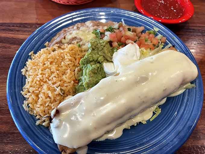 That chimichanga is generously blanketed in cheese sauce, proving that comfort food knows no borders or boundaries.