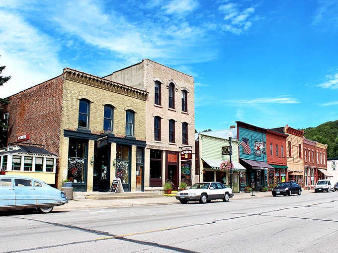Classic cars cruise past century-old buildings where actual businesses thrive, not just Instagram opportunities.