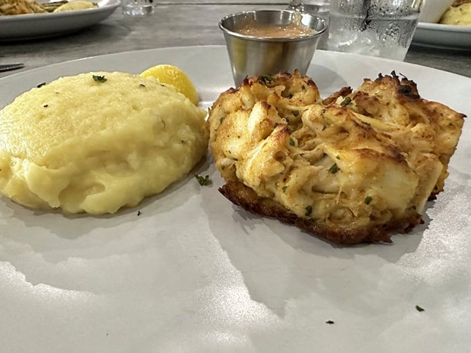 Golden-crusted crab cakes paired with creamy sides prove that sometimes perfection comes in the simplest, most delicious packages.