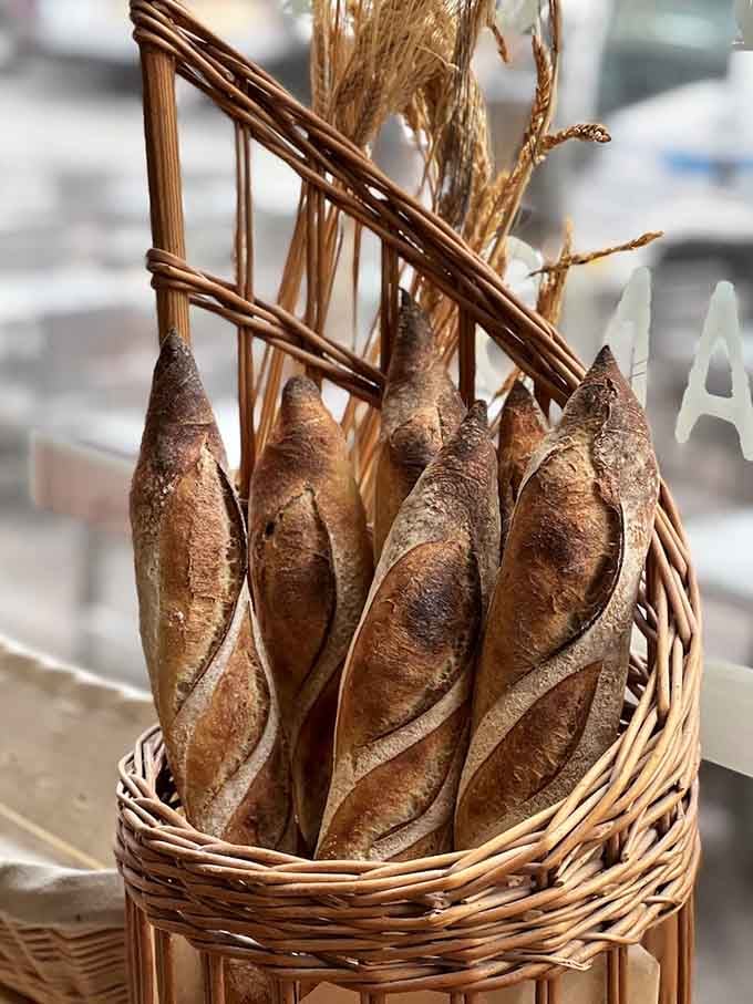 These baguettes stand at attention like edible soldiers, their golden crusts crackling with traditional French perfection and pride.
