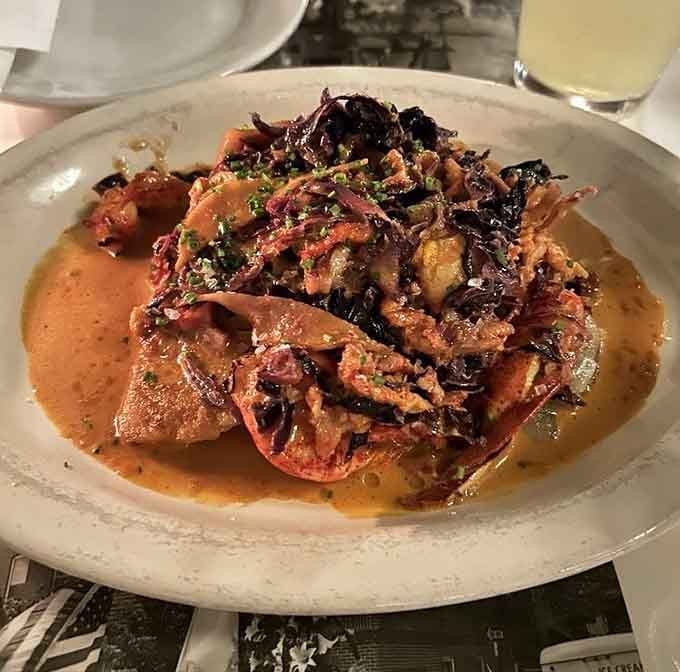 Lobster pierogies swimming in sauce with crispy toppings prove that Polish comfort food can absolutely wear a tuxedo when needed.