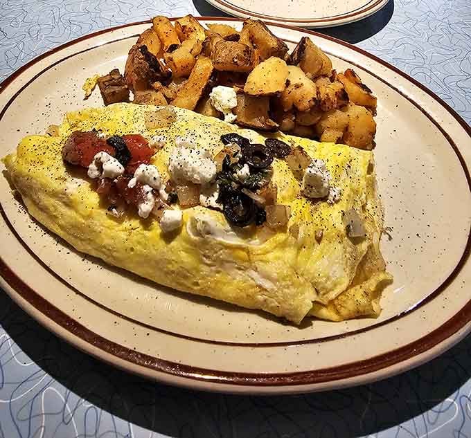 That Greek omelette loaded with feta and veggies alongside golden home fries is breakfast done absolutely right.