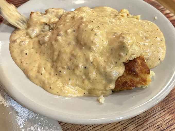 Behold: fluffy biscuits drowning in peppery sausage gravy that could make a grown person weep with joy.