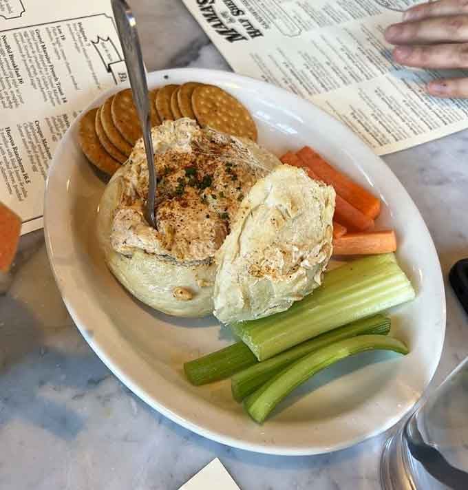 Behold the legendary crab dip, generously loaded with actual crab meat and surrounded by eager crackers and vegetables.