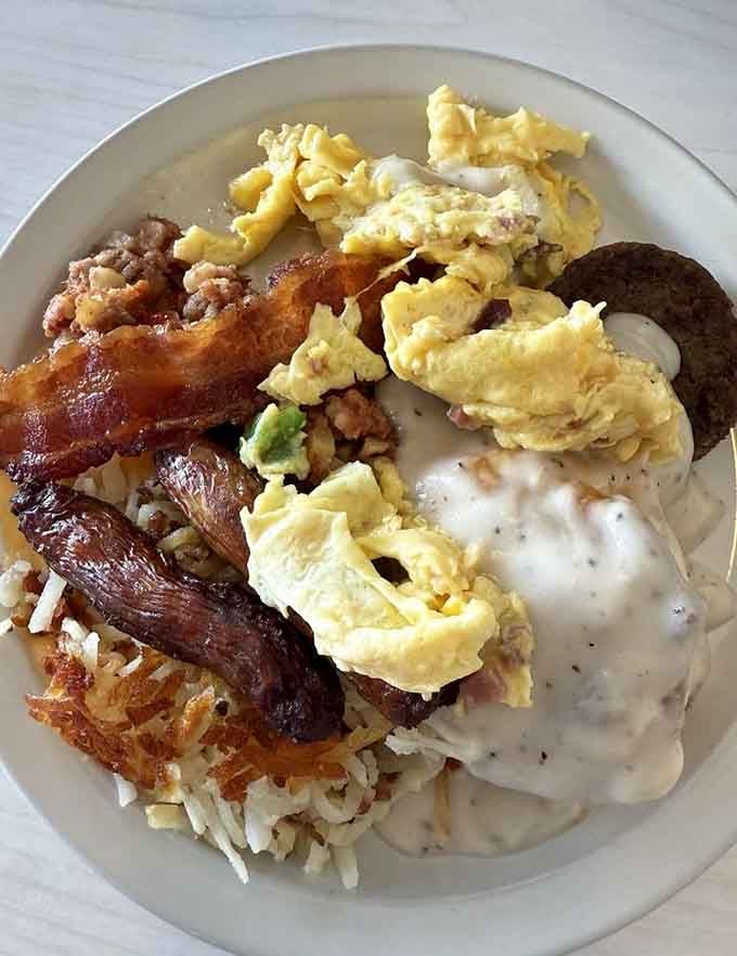 Hash browns, scrambled eggs, bacon, sausage, and gravy prove that breakfast doesn't need to be complicated to be perfect.