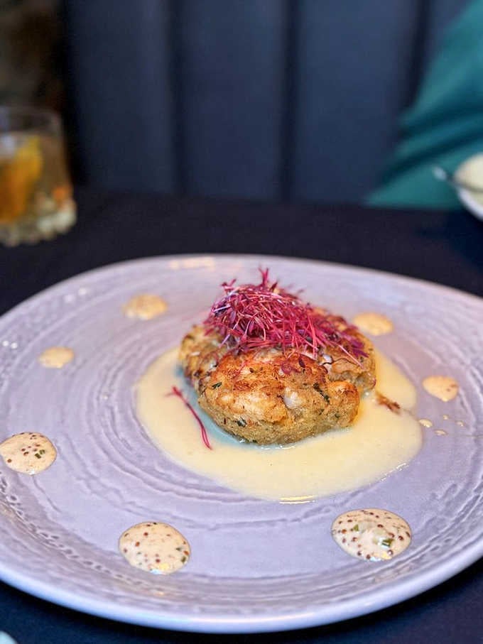 Golden-crusted perfection topped with delicate microgreens, this crab cake knows exactly what it's doing on that plate.