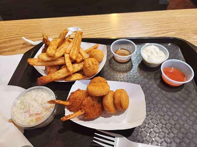 This is what happiness looks like: golden fish, crispy hush puppies, and enough fries to share (but you won't).