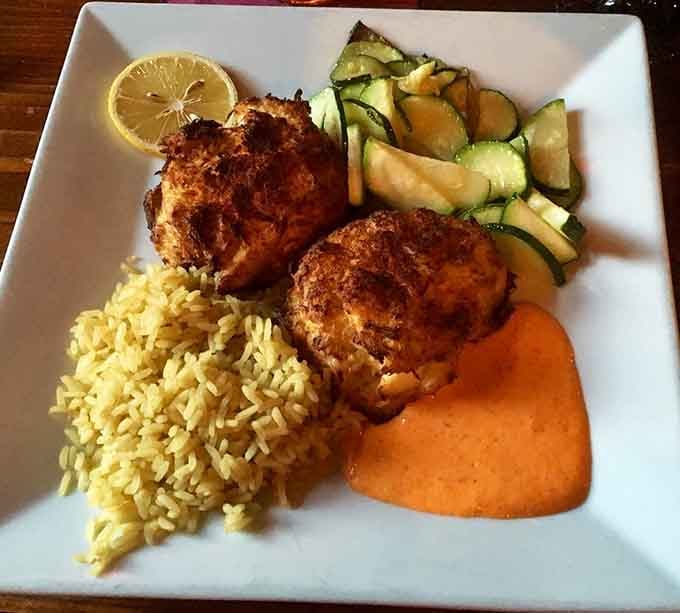 Twin crab cakes over cilantro lime rice prove that seafood and history make excellent dining companions together.