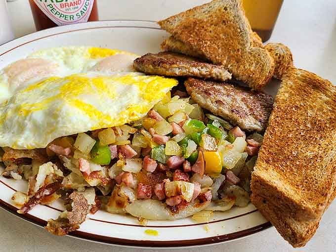 Eggs, sausage, hashbrowns, and toast working together like a perfectly cast ensemble in your favorite comfort show.