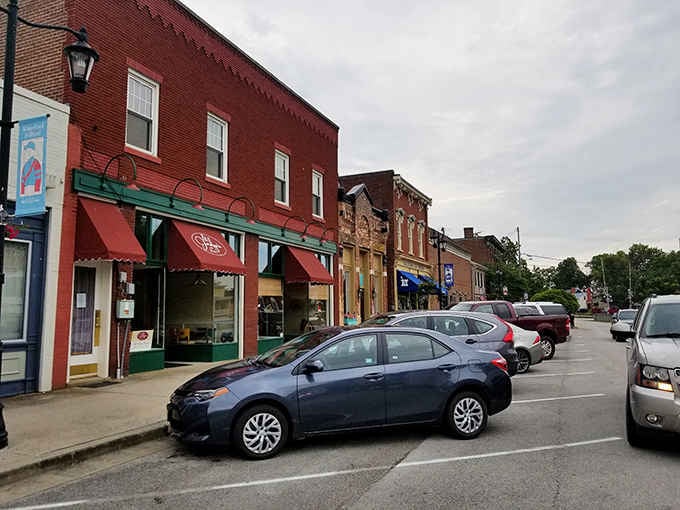 Colorful storefronts line streets where people still wave to strangers passing by on the sidewalk.