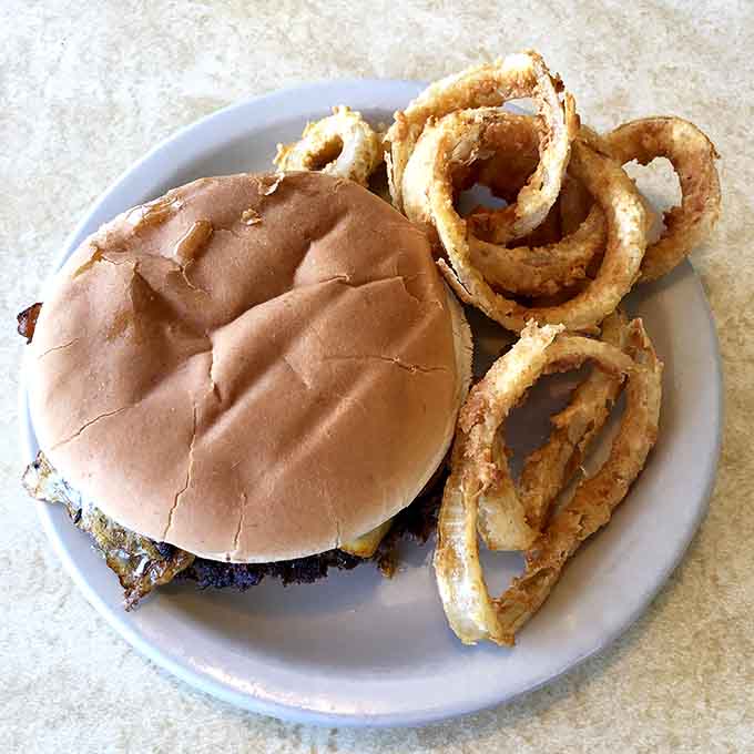 When your burger comes with onion rings that golden and crispy, you know someone in that kitchen truly understands life.