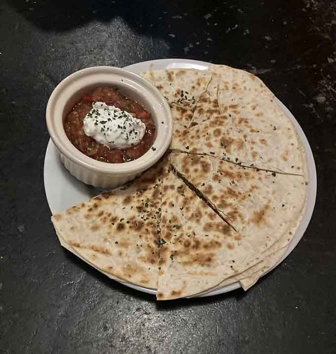 Golden, grilled quesadilla wedges with that dollop of sour cream prove comfort food doesn't need a PhD to be delicious.