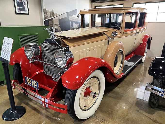 Red and cream elegance on whitewall tires, this beauty represents the era when cars were status symbols you could actually afford.