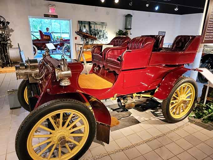 Deep burgundy paint on those wooden wheels screams early 1900s elegance and adventure.