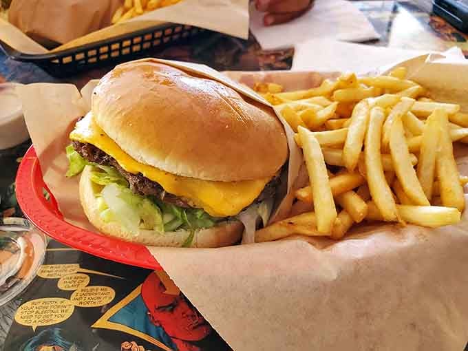 A perfectly constructed classic burger that proves sometimes simplicity is the ultimate sophistication, with golden fries alongside.