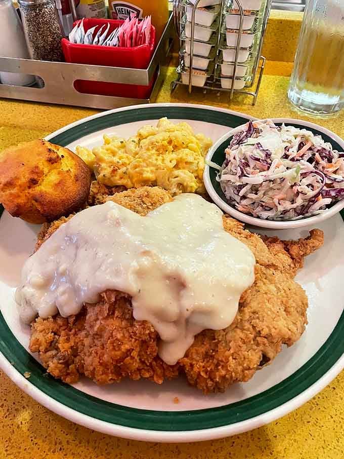 Country fried steak smothered in gravy with mac and cheese proves comfort food is an art form.