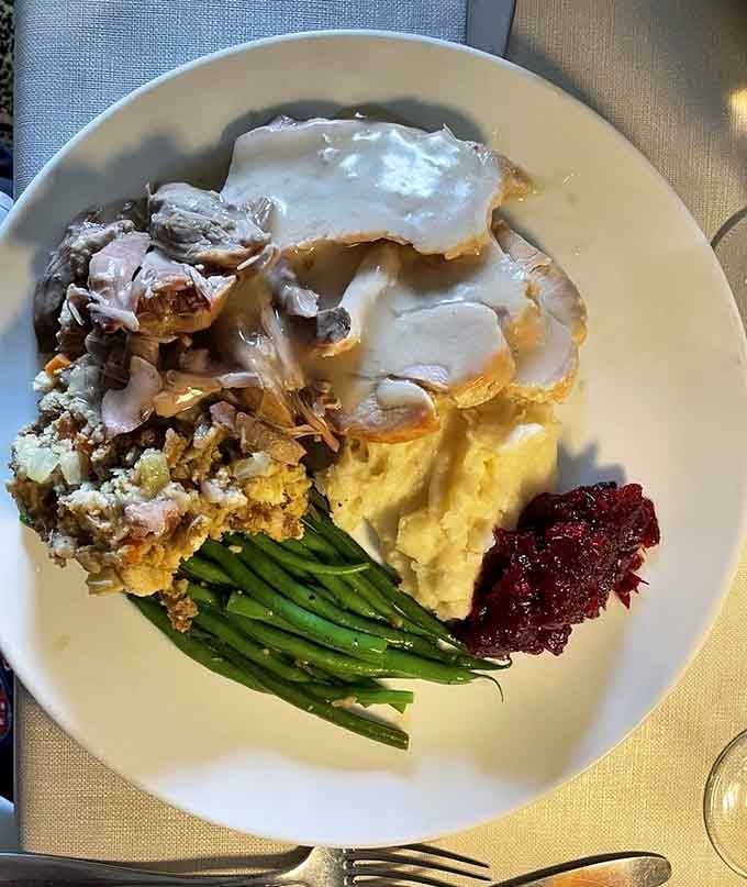 Turkey dinner plated so beautifully it almost makes you forget about every dry Thanksgiving you've ever endured.