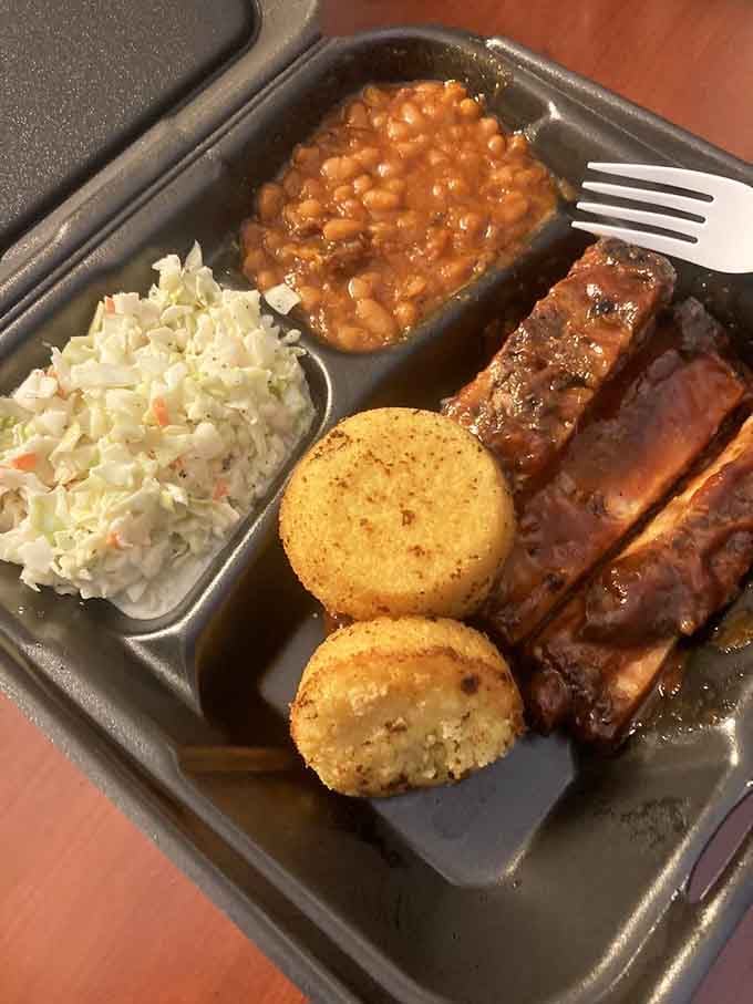 Ribs, beans, slaw, and cornbread on one plate: basically the Mount Rushmore of Kentucky comfort food.