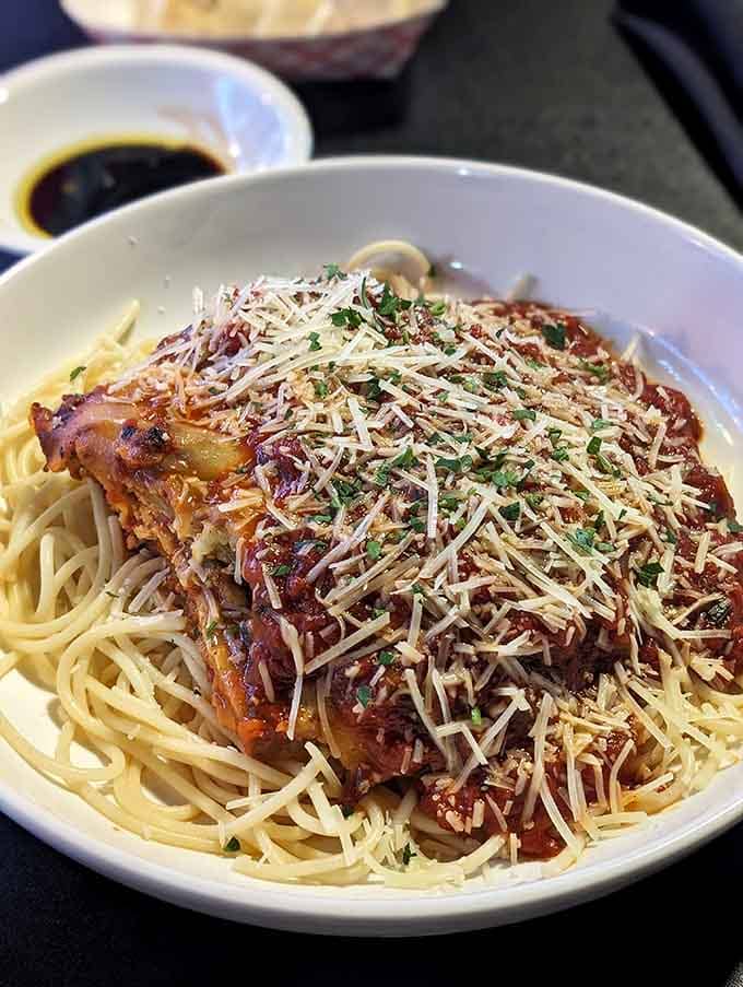 Chicken parmesan over spaghetti with enough cheese to make your cardiologist nervous and your taste buds absolutely ecstatic tonight.