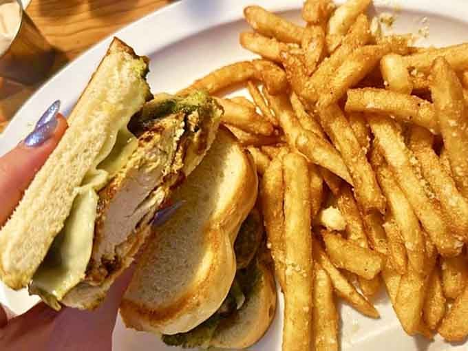 That pesto grilled chicken sandwich towers like a delicious skyscraper begging to be conquered with both hands.