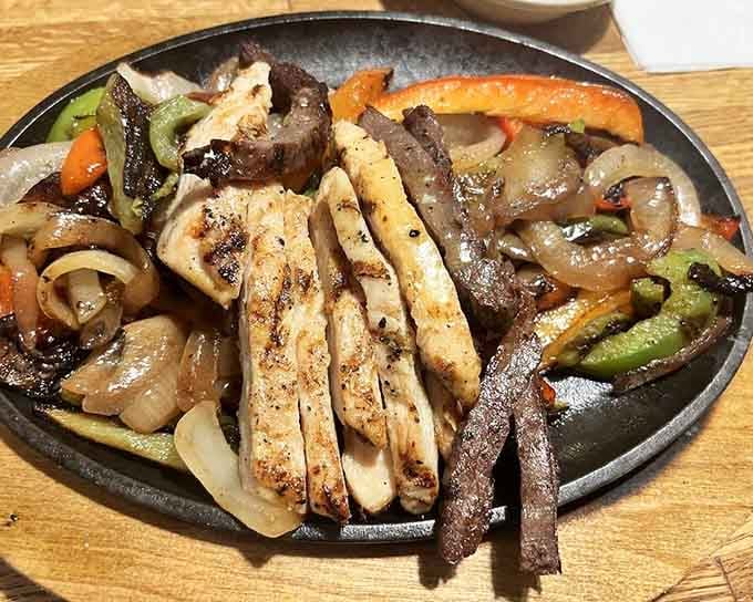 Sizzling fajitas arriving at your table like they're making a grand entrance at the Oscars.