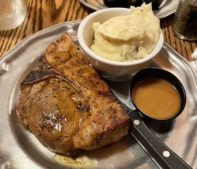 That pork chop could arm wrestle you and win, served with mashed potatoes that understand their supporting role perfectly.
