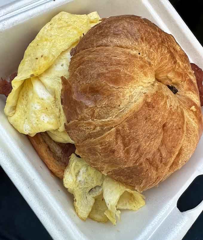 That flaky croissant sandwich with eggs is basically a buttery hug for your taste buds.